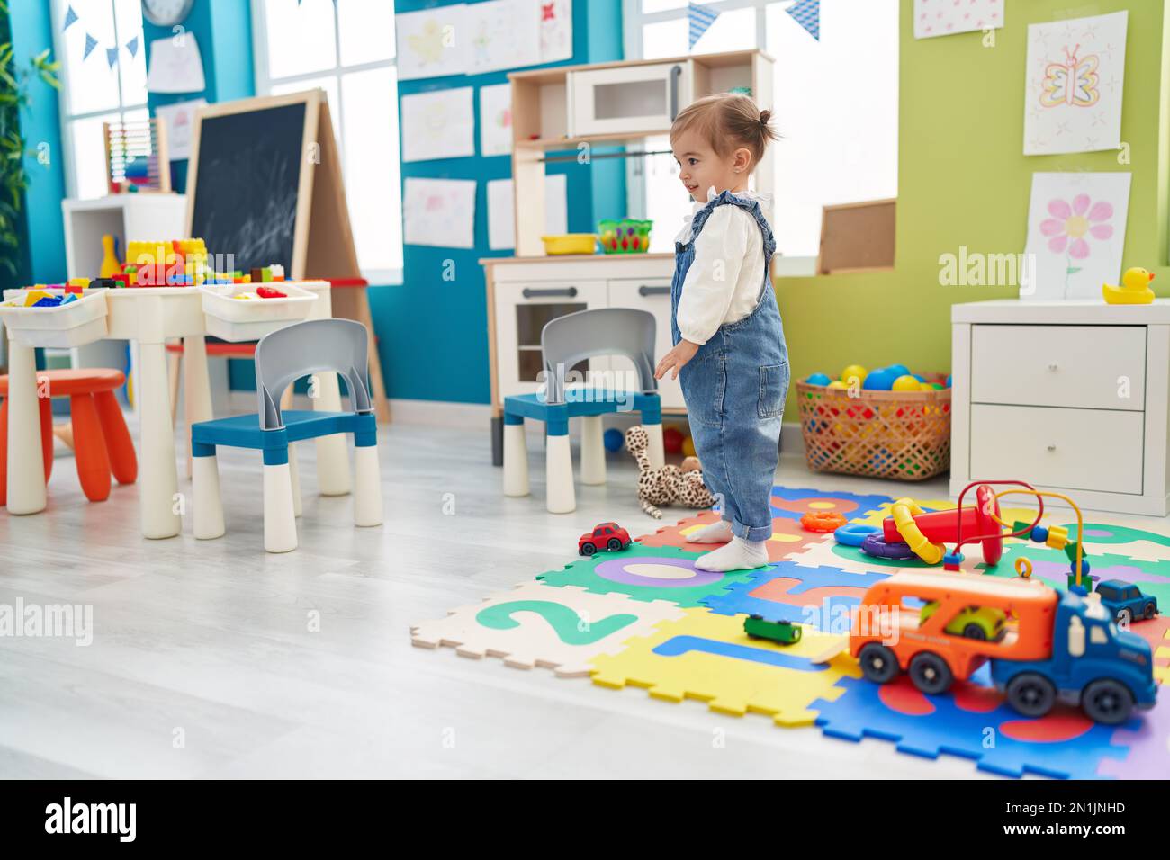 Adorable blonde toddler smiling confident standing at kindergarten Stock Photo - Alamy