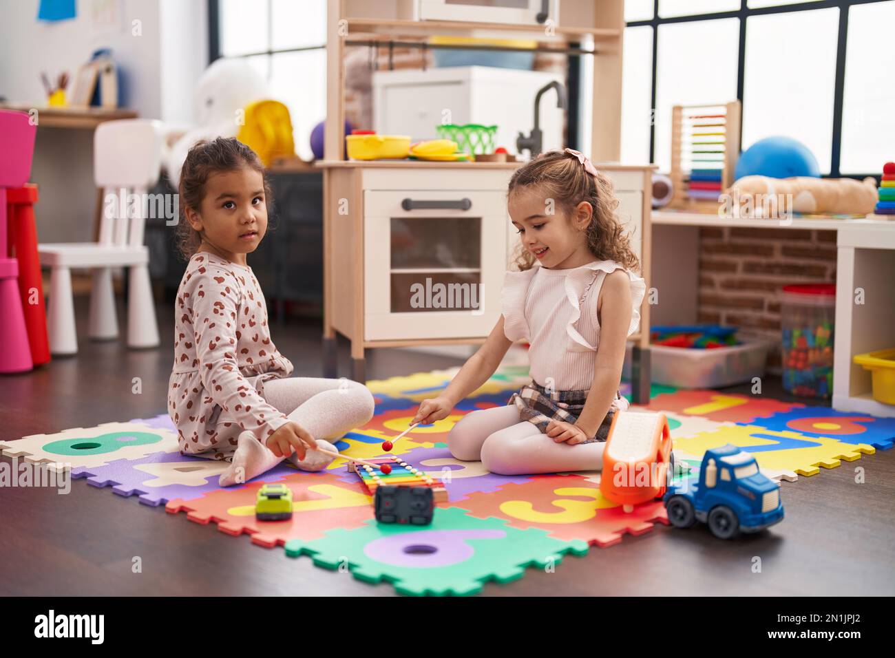 Two kids playing xylophone hi-res stock photography and images - Alamy