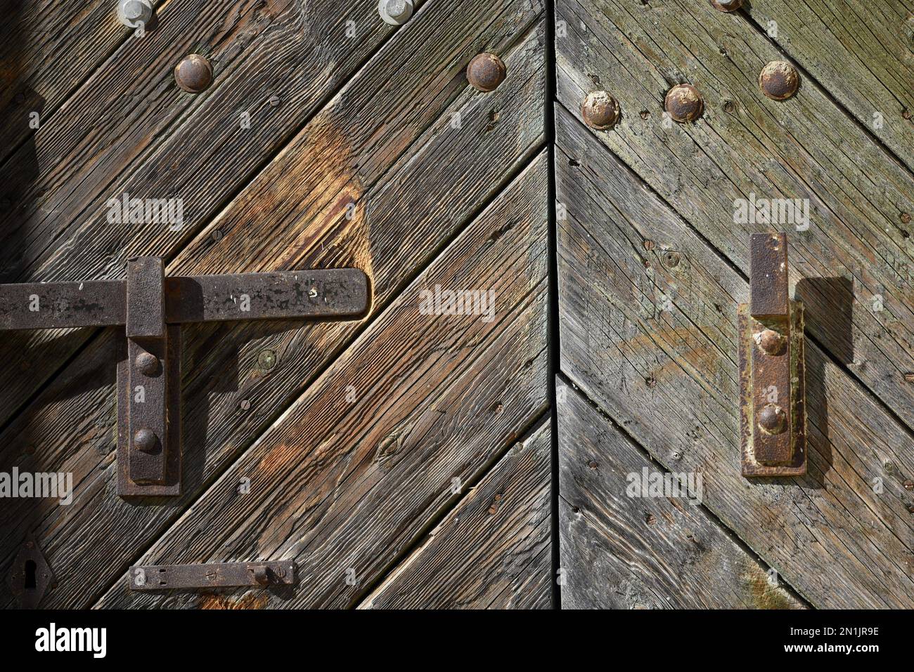 Old farmhouse antique wooden entrance gate with a rusty security bar ...