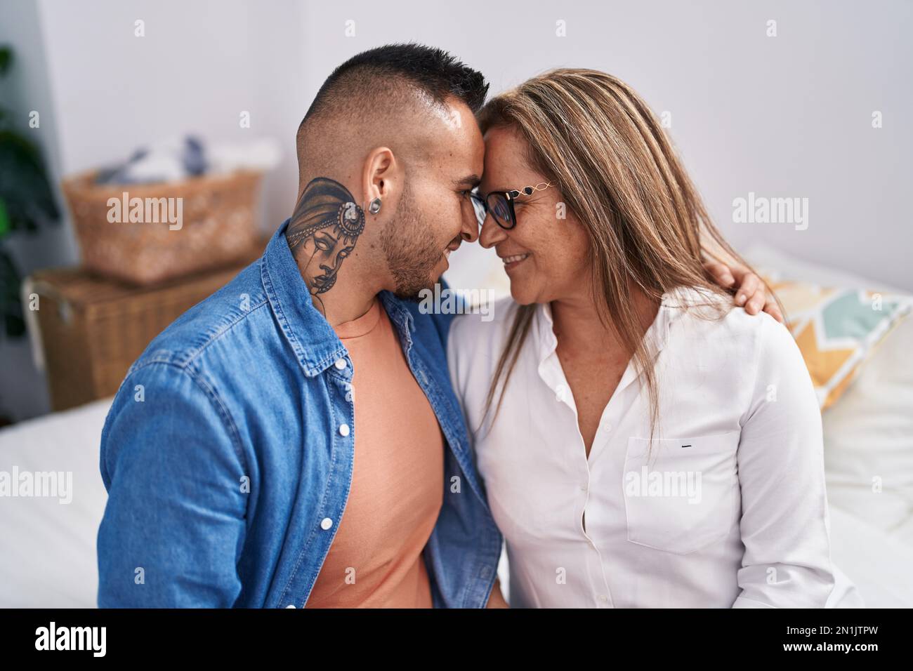 Man and woman mother and son hugging each other at bedroom Stock Photo ...