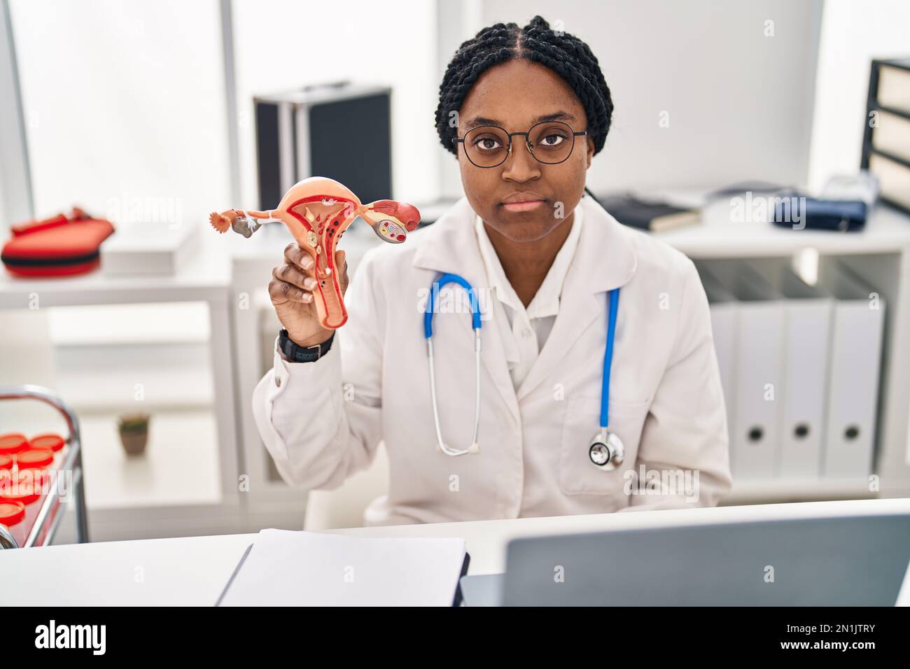 African american doctor woman holding anatomical model of female ...