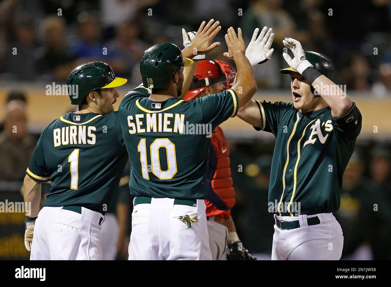 Oakland Athletics' Mark Canha, right, is congratulated by Billy Burns ...