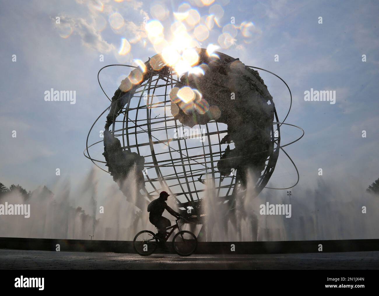A cyclist passes the Unisphere inside Flushing Meadows Corona Park ...