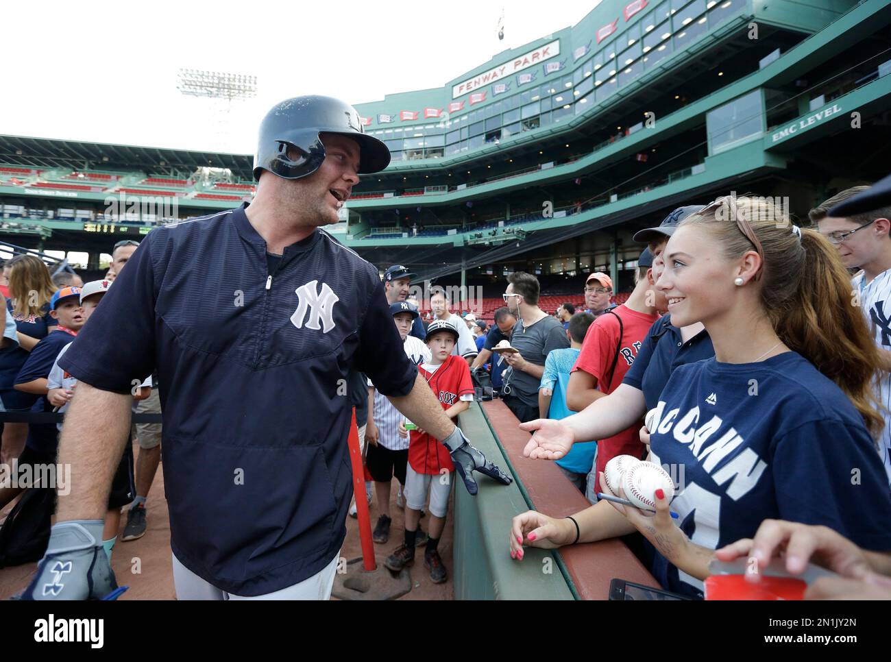 New York Yankees catcher Brian McCann, left, speaks with fans after ...