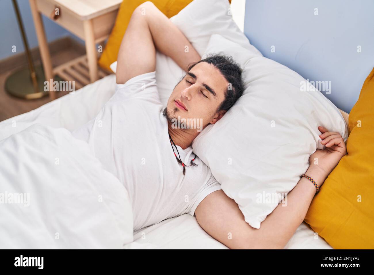 Young man sleeping on bed at bedroom Stock Photo - Alamy