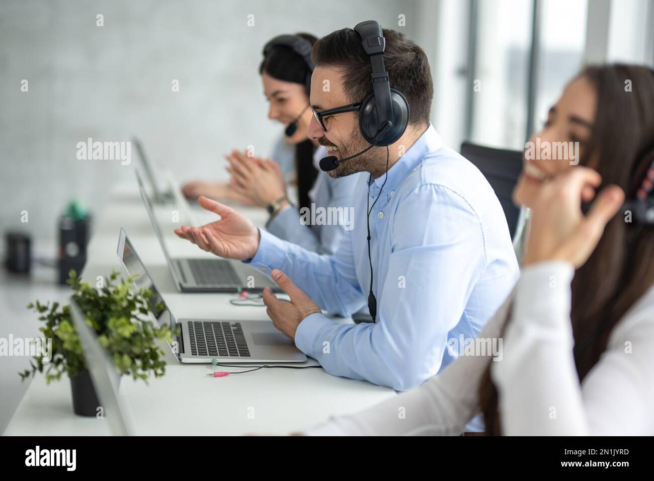 Side view portrait of handsome male IT support executive agent talking ...