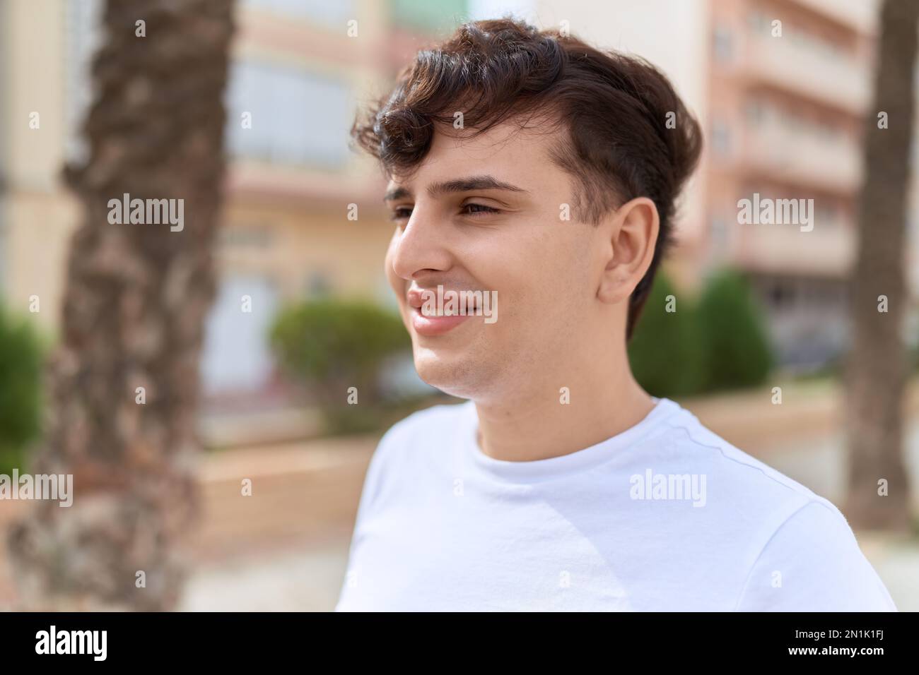 Non binary man smiling confident looking to the side at park Stock ...