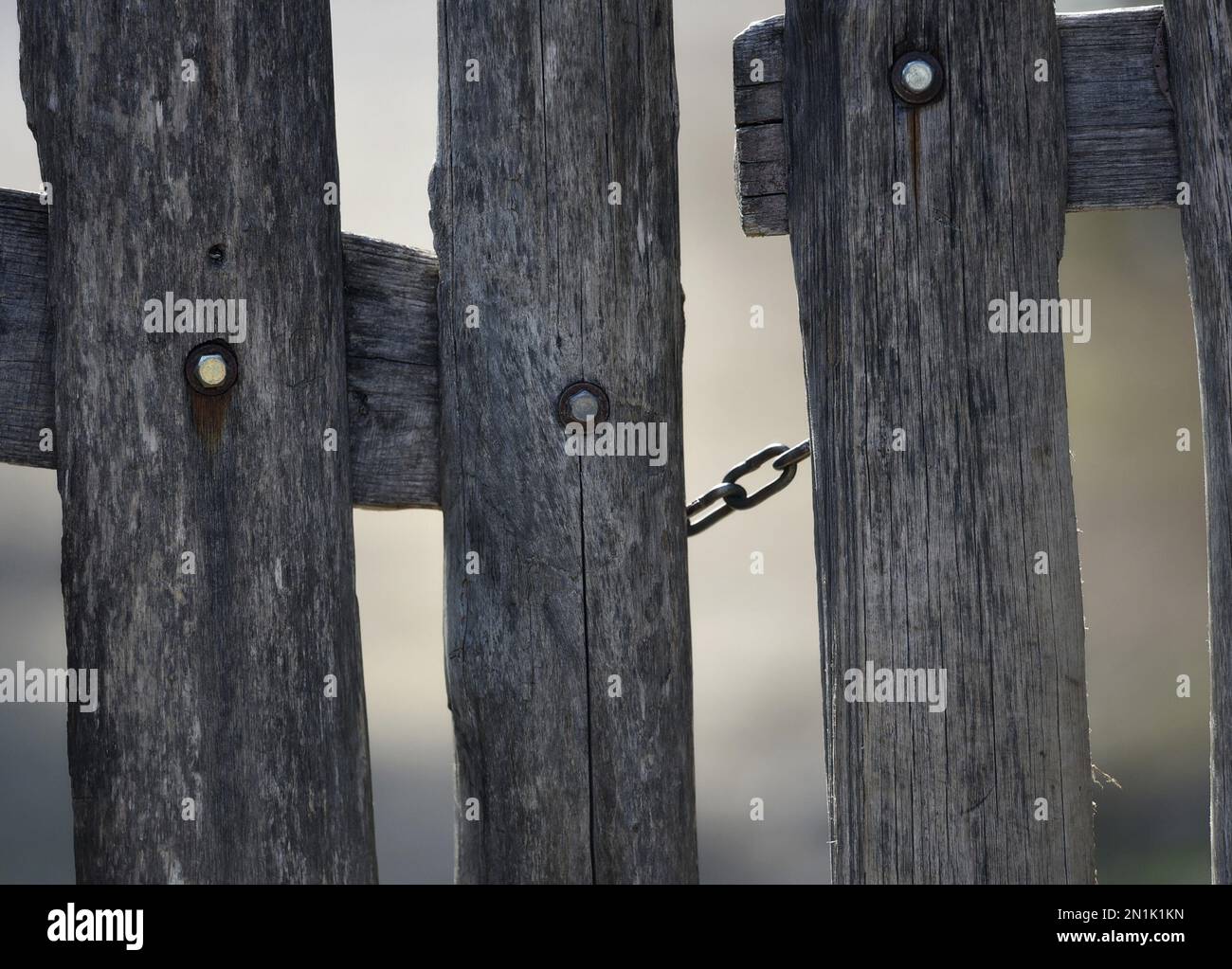 Handmade fence with tree trunk posts Stock Photo - Alamy