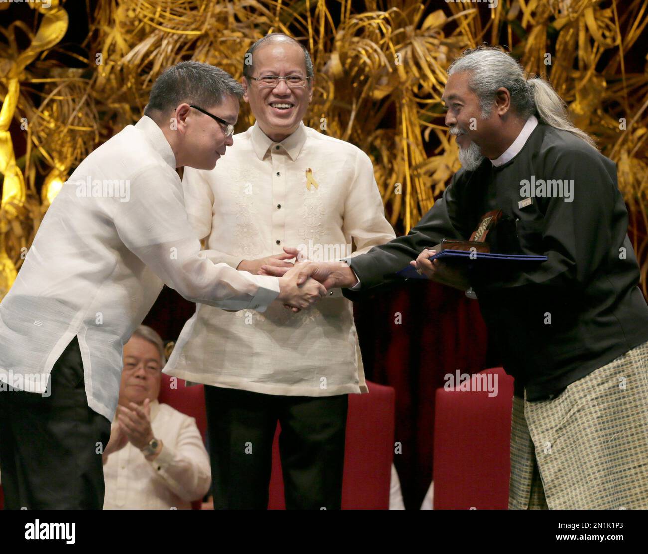 Kyaw Thu, right, of Myanmar is congratulated by Fr. Jose Ramon Villarin ...