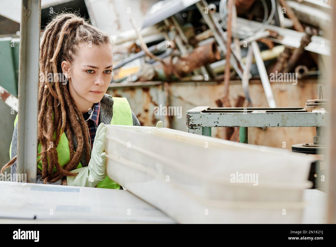 Volunteer sorting garbage at materials recovery facility Stock Photo ...