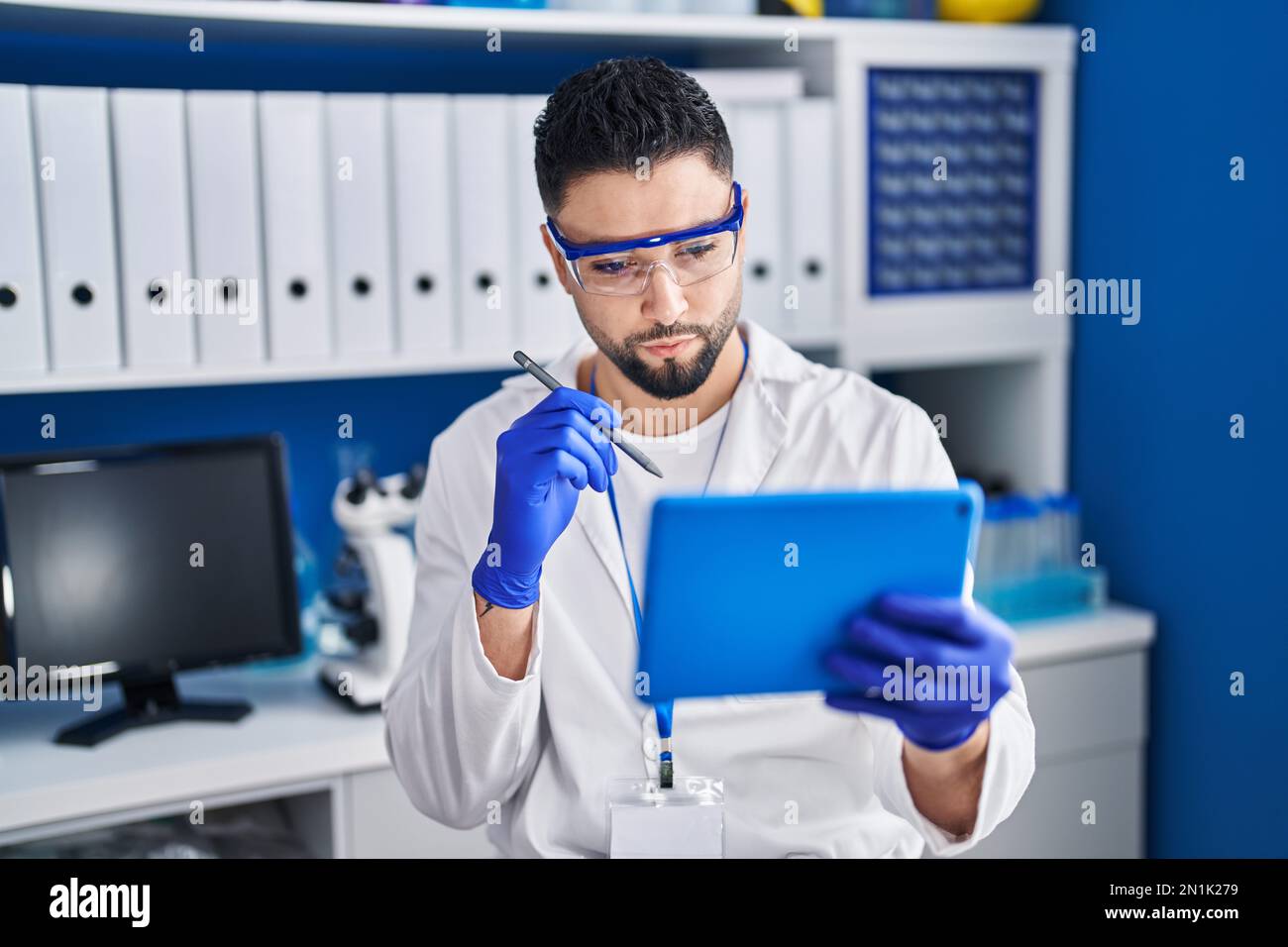 Young arab man scientist using touchpad working at laboratory Stock ...