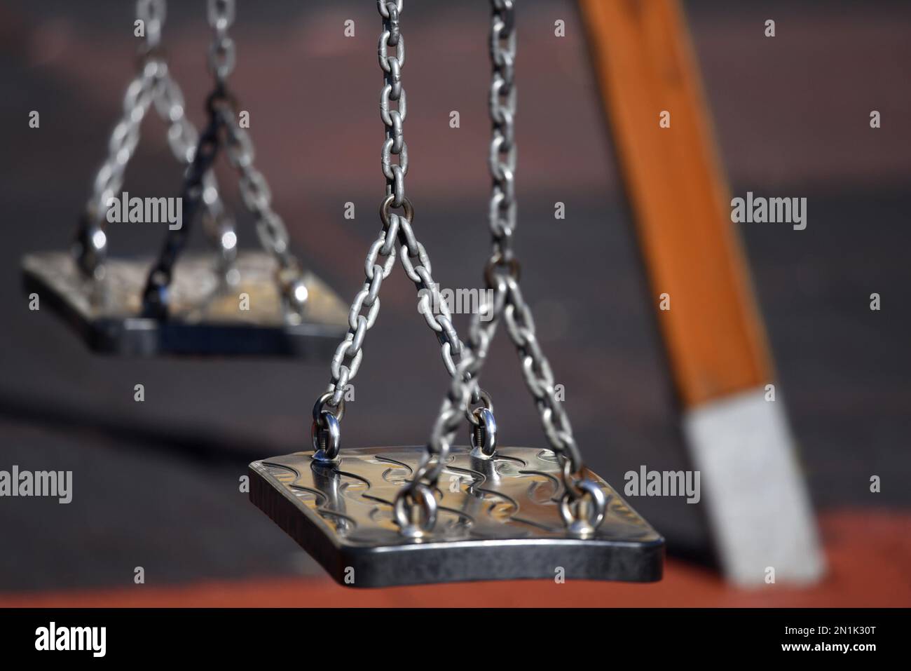 Outdoor kids playground hanging swing seat with chains Stock Photo - Alamy