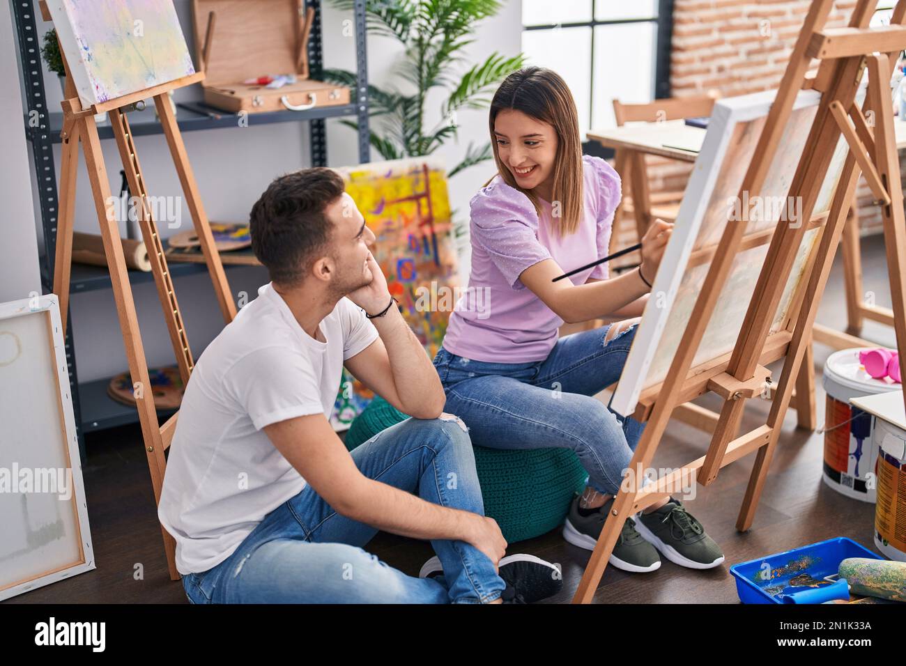 Man and woman artists couple smiling confident drawing at art studio ...