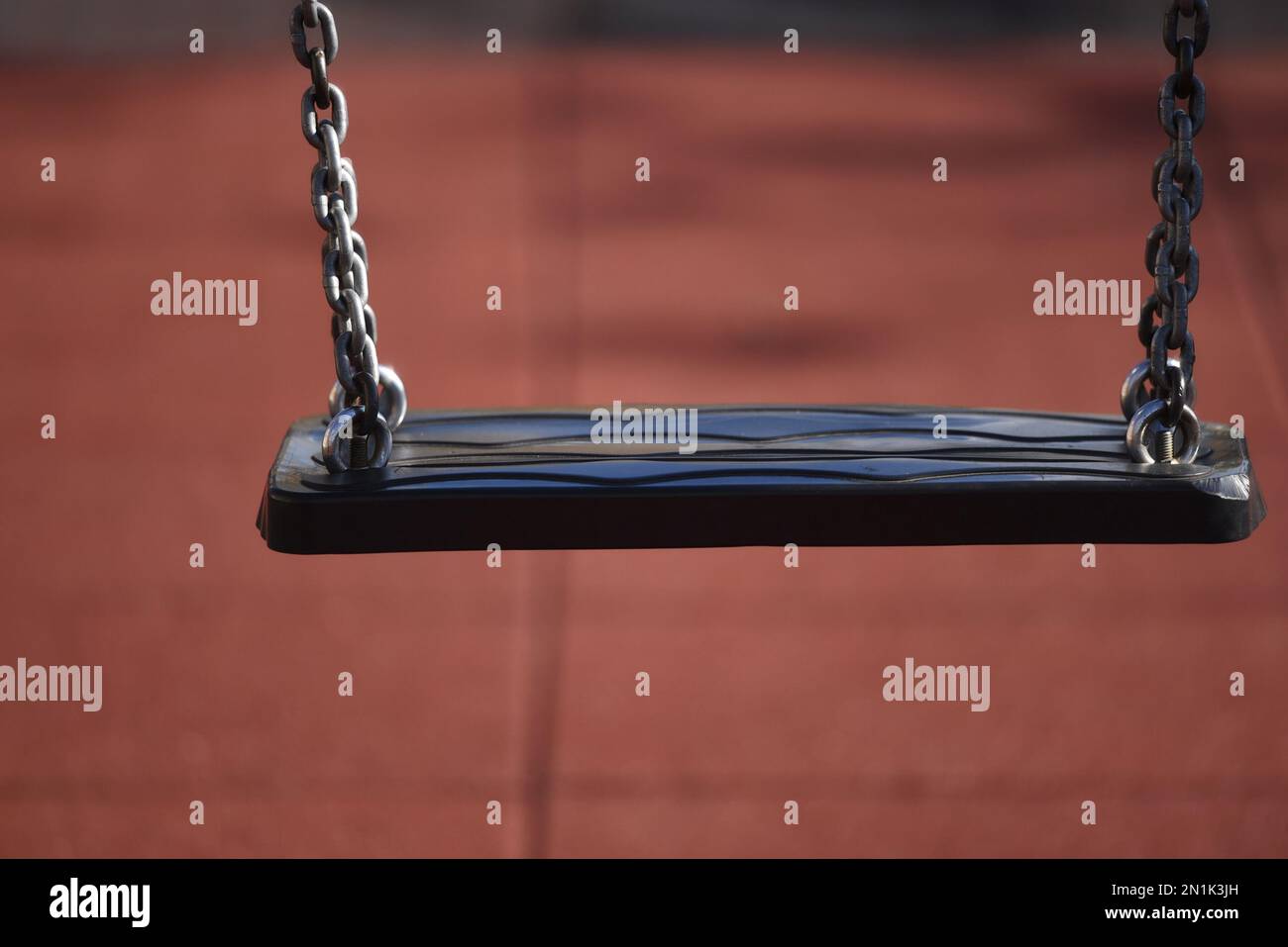 Outdoor kids playground hanging swing seat with chains Stock Photo - Alamy