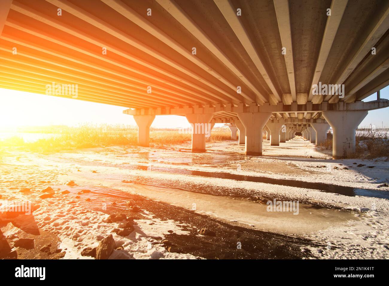 Columns motor transport bridge background sunset and a frozen river ...