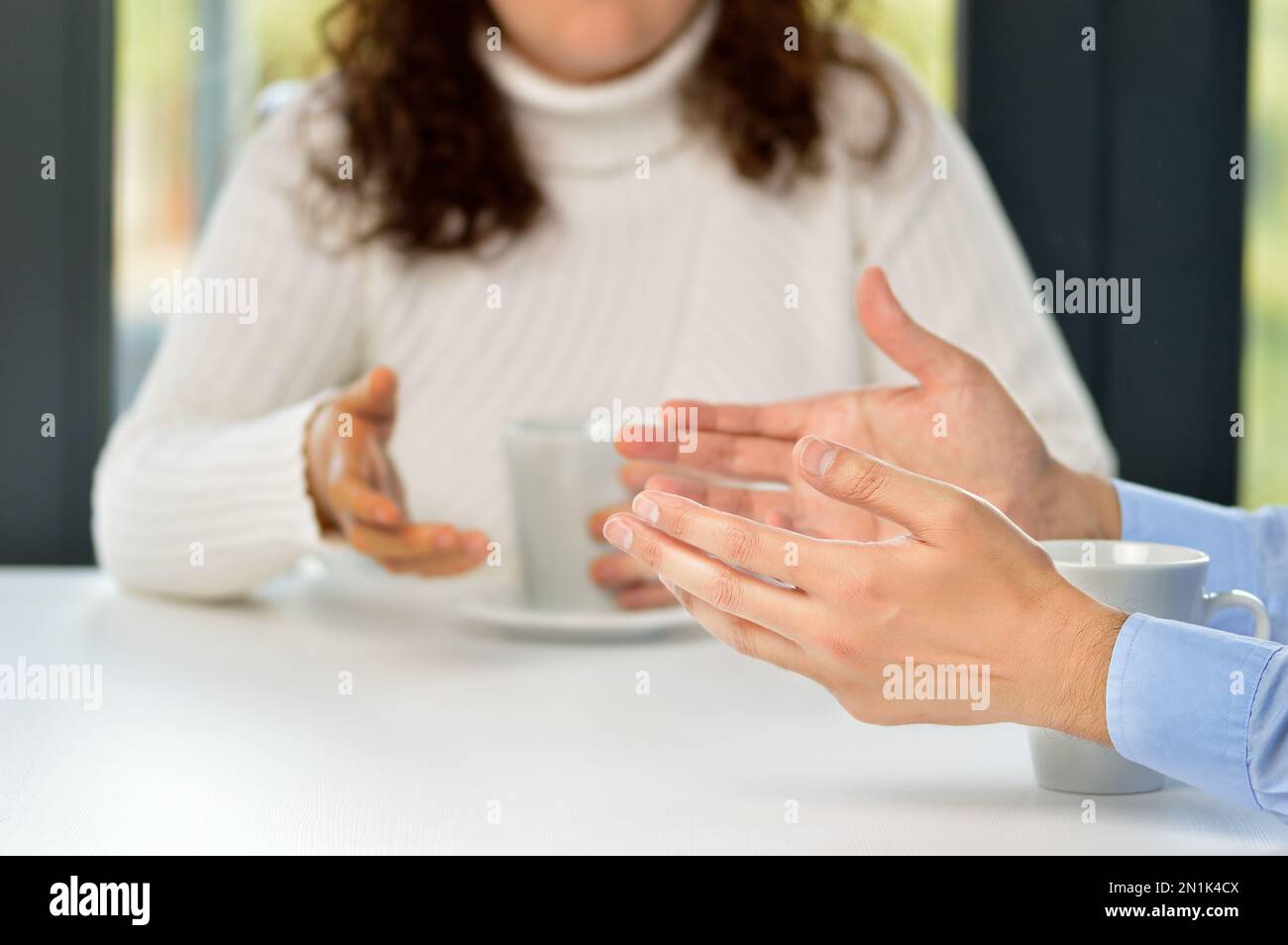 Two friends hands talking in a bar Stock Photo - Alamy