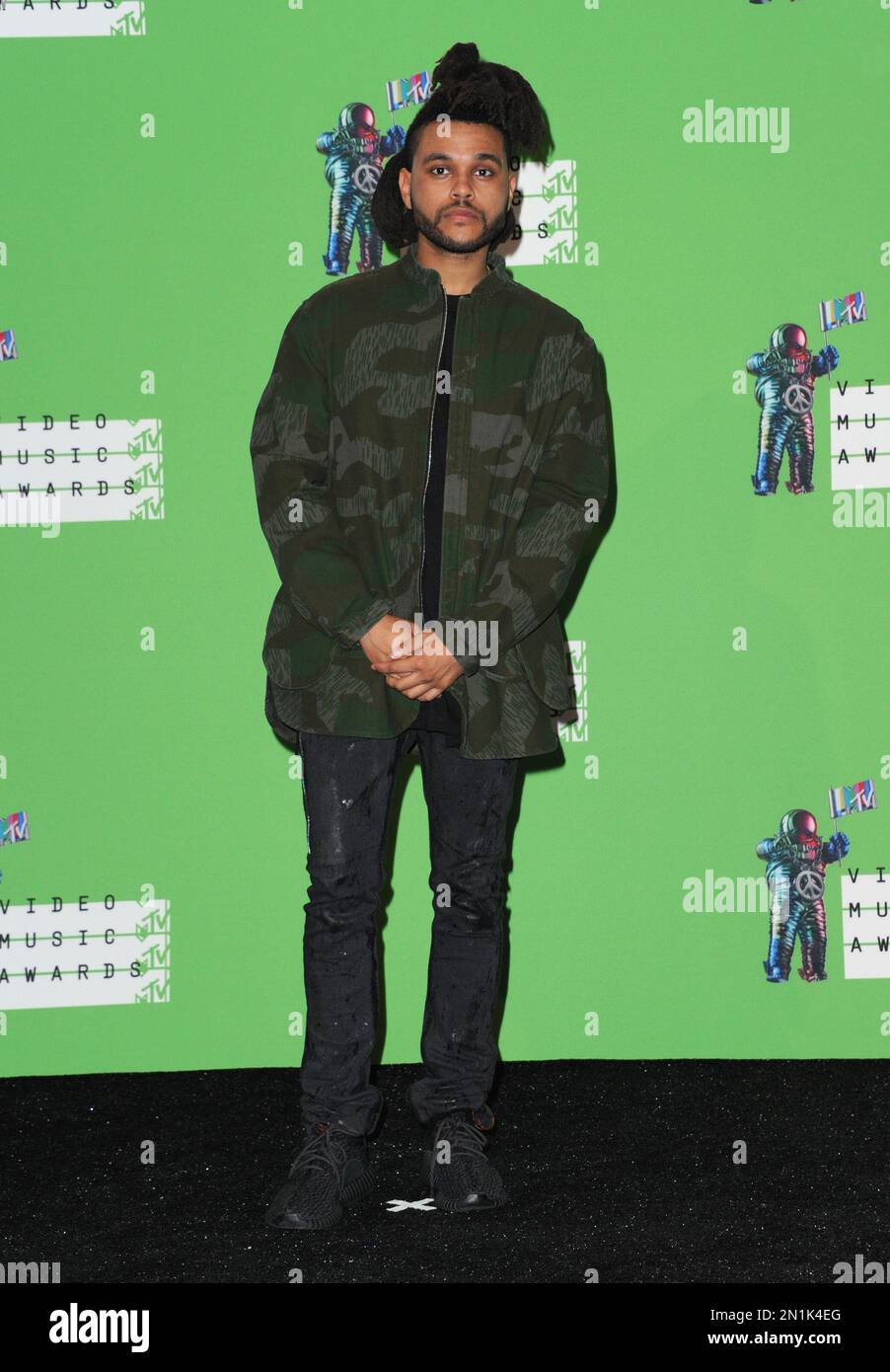 The Weeknd poses in the press room at the MTV Video Music Awards at the ...