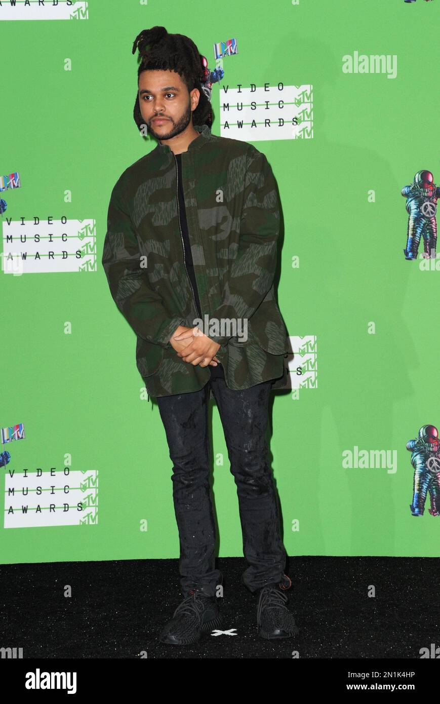 The Weeknd poses in the press room at the MTV Video Music Awards at the ...