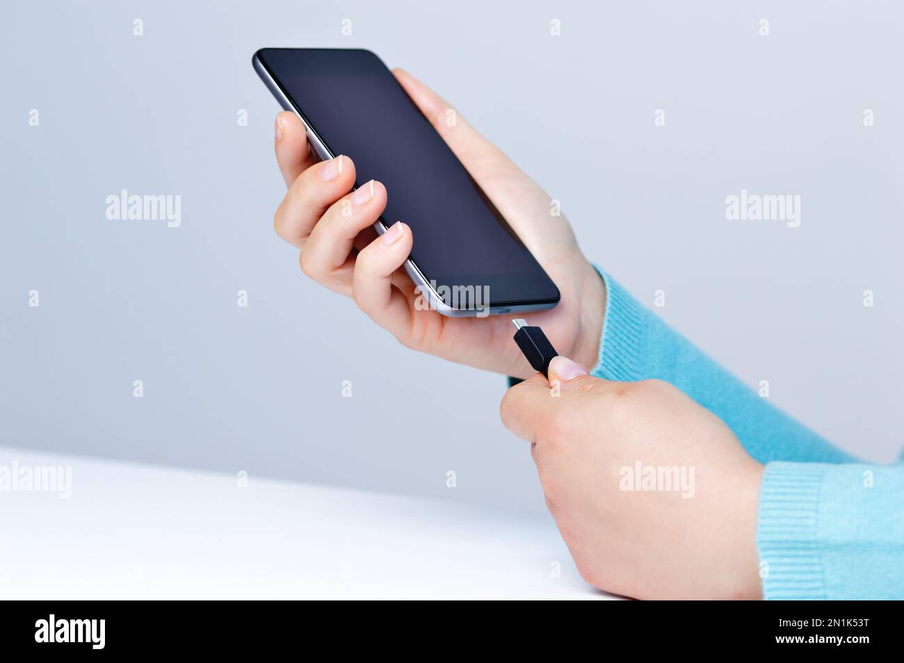 Plugging charger into mobile telephone hi-res stock photography and ...