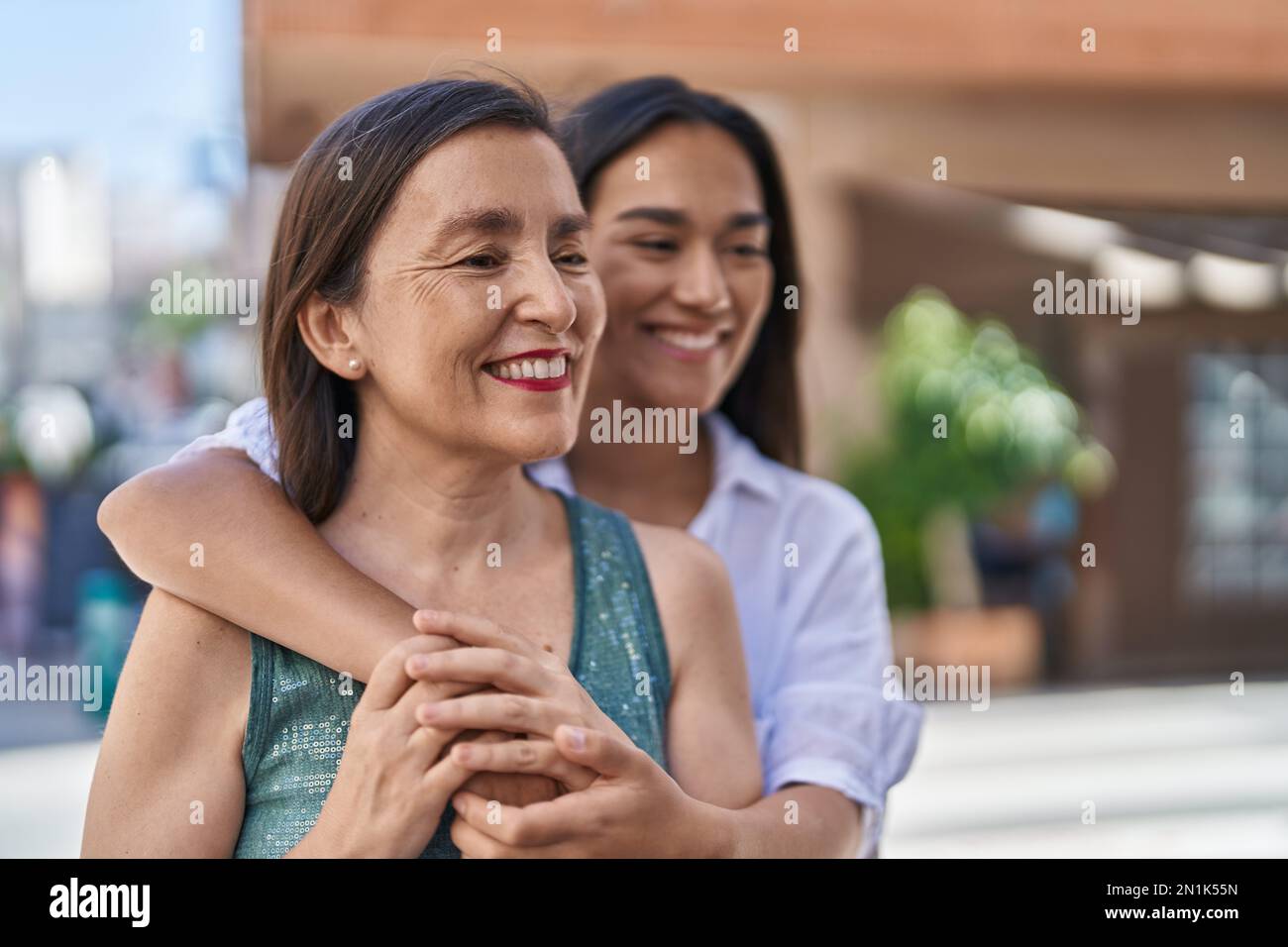Two women mother and daughter smiling confident hugging each other at street Stock Photo - Alamy