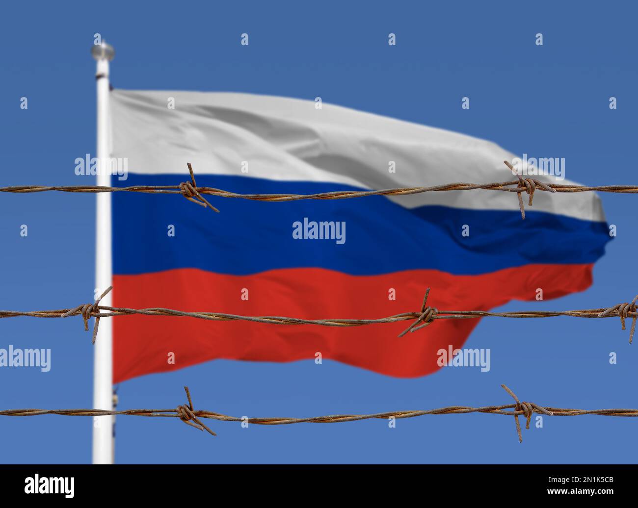 Metal fence with barbed wire on a russian flag. Separation concept ...
