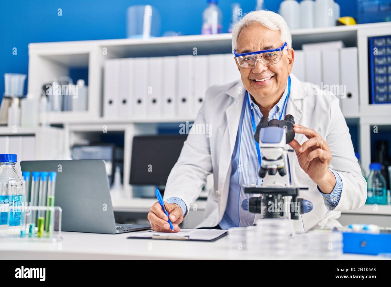 Senior man scientist using microscope working at laboratory Stock Photo - Alamy