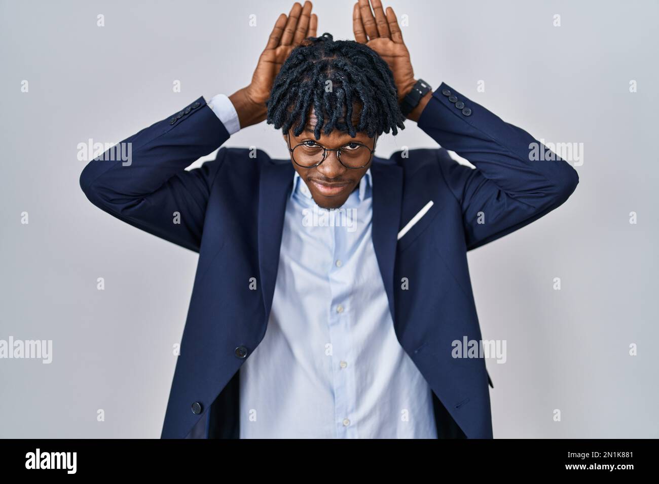 Young african man with dreadlocks wearing business jacket over white ...