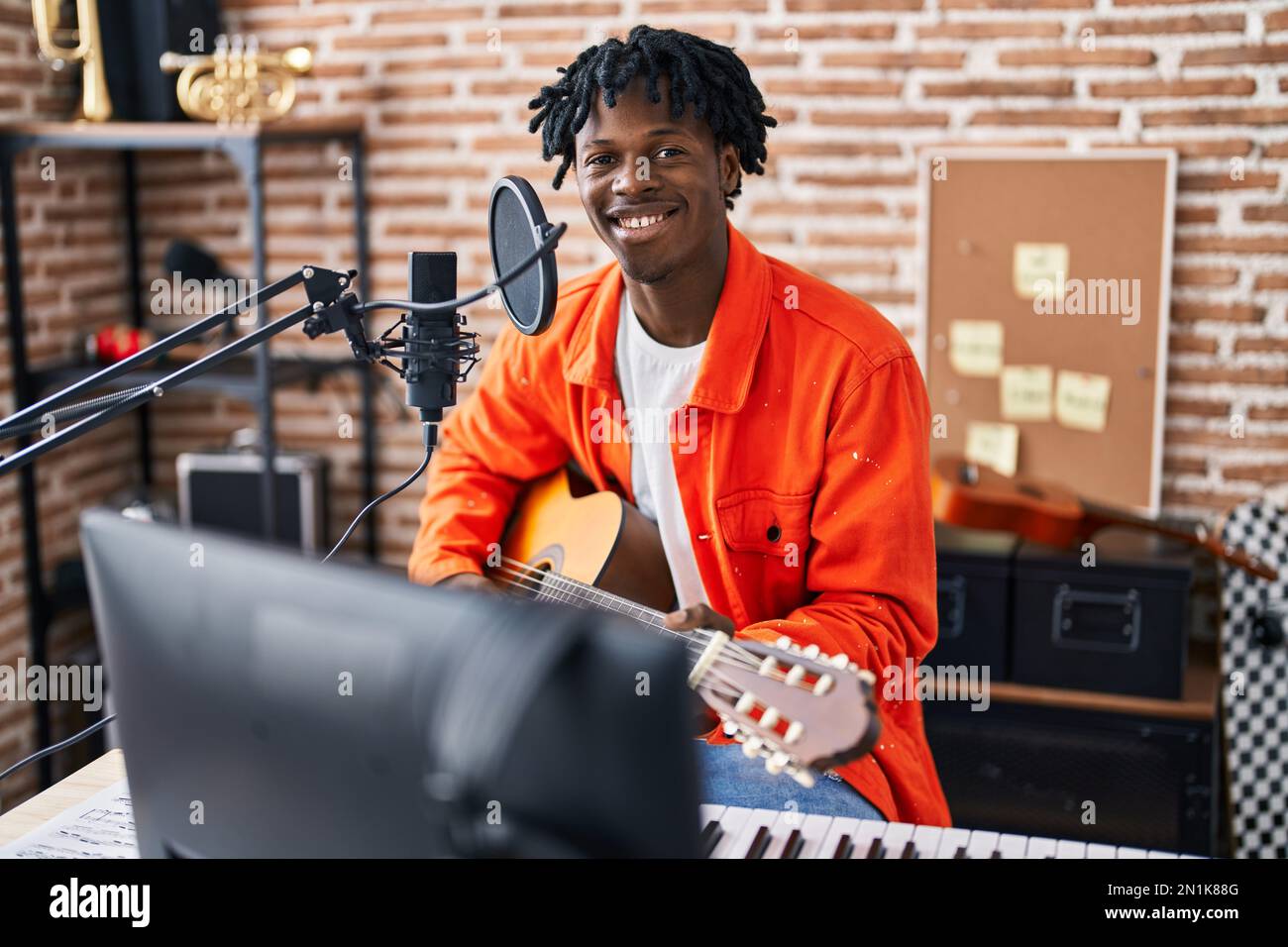 African american man singing song playing classical guitar at music ...