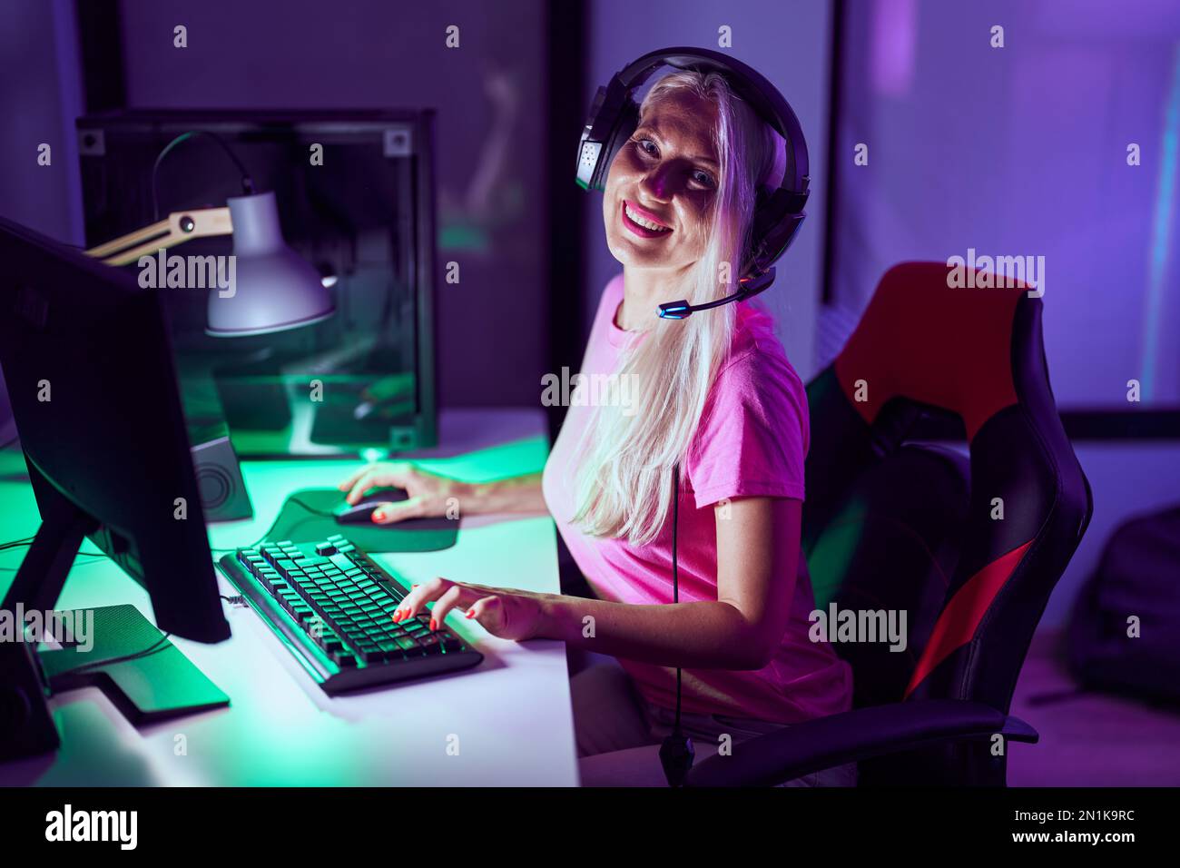 Young blonde woman streamer smiling confident using computer at gaming ...