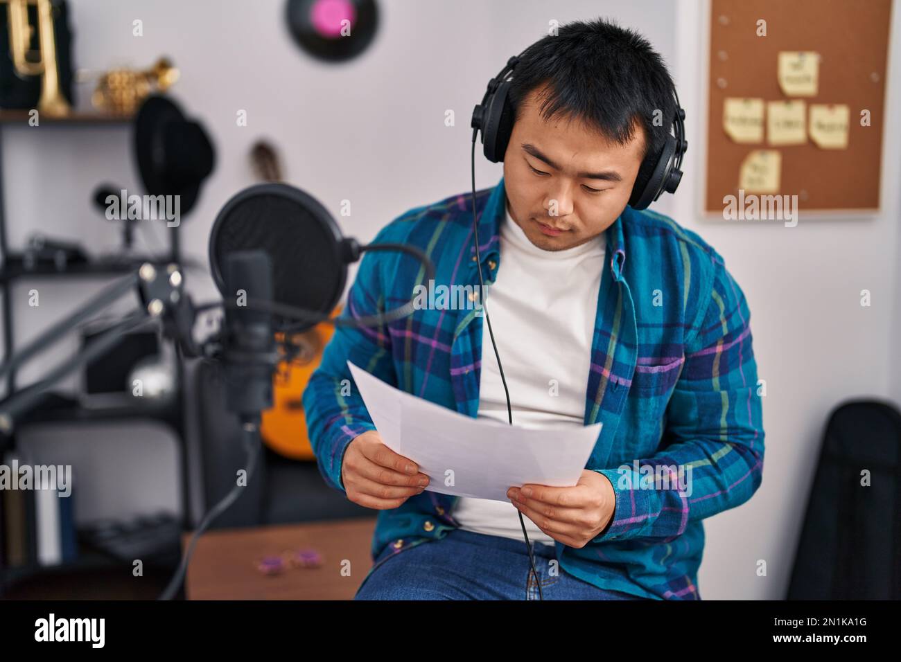 Young chinese man singer singing song at music studio Stock Photo - Alamy