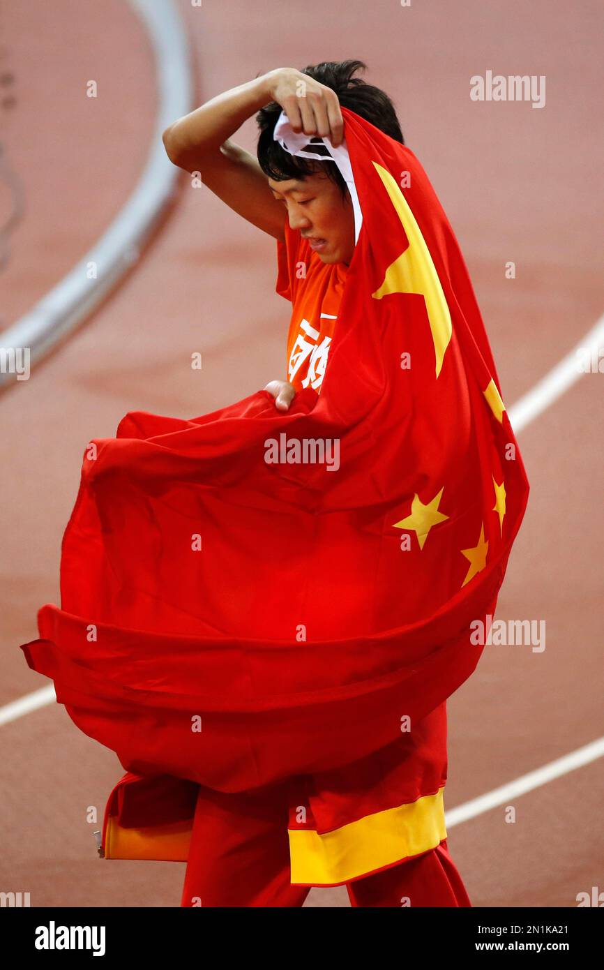 China's Zhang Guowei covers himself in the national flag after men’s ...