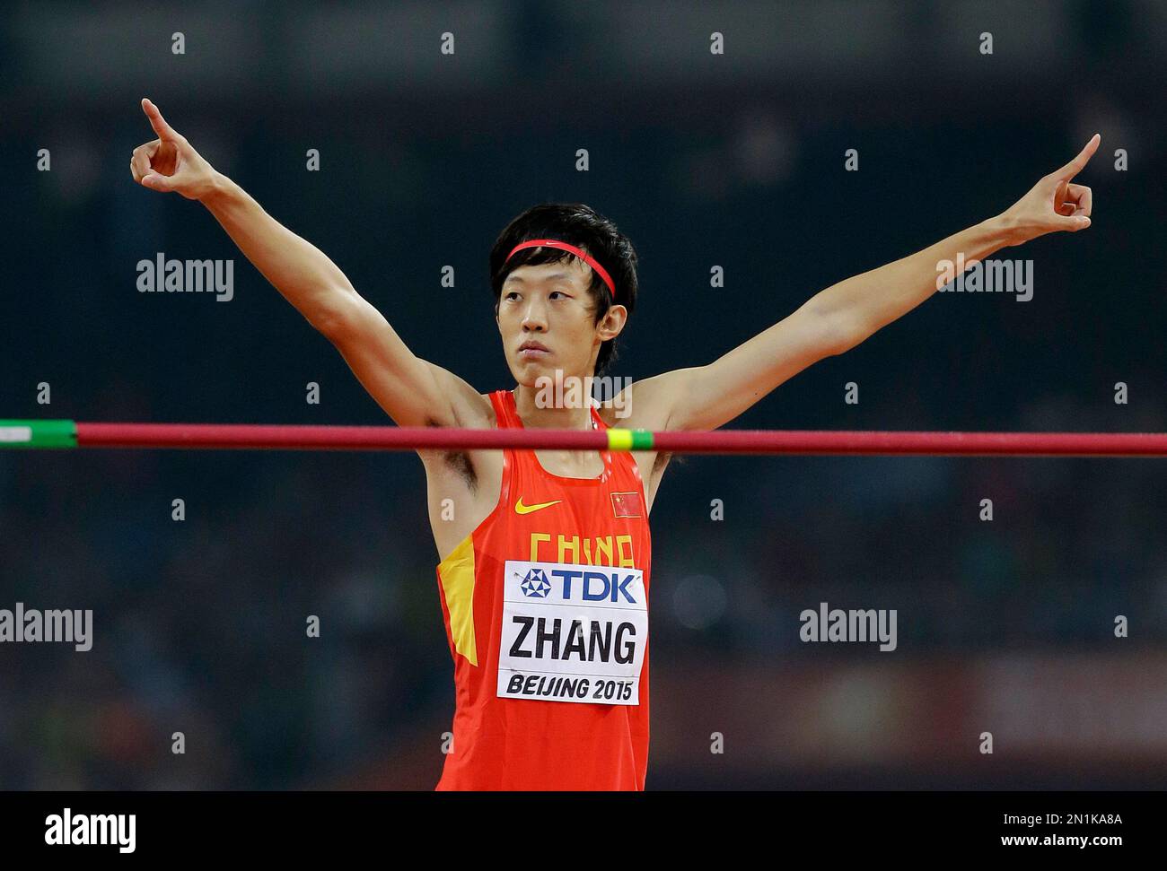 China's Zhang Guowei celebrates after a successful jump in the men's ...