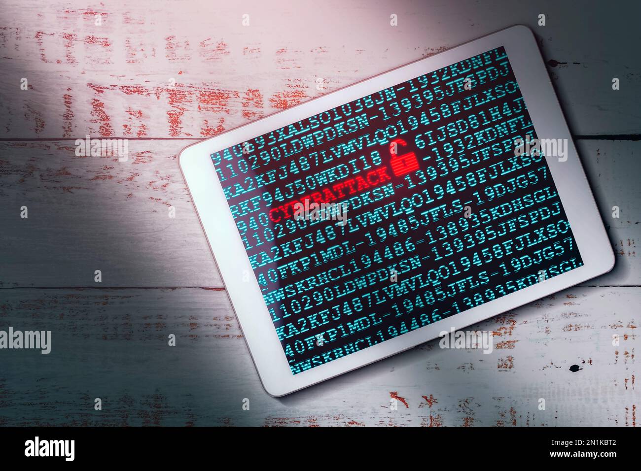 Top view of digital tablet with cyber attack warning on screen. Cyber ...
