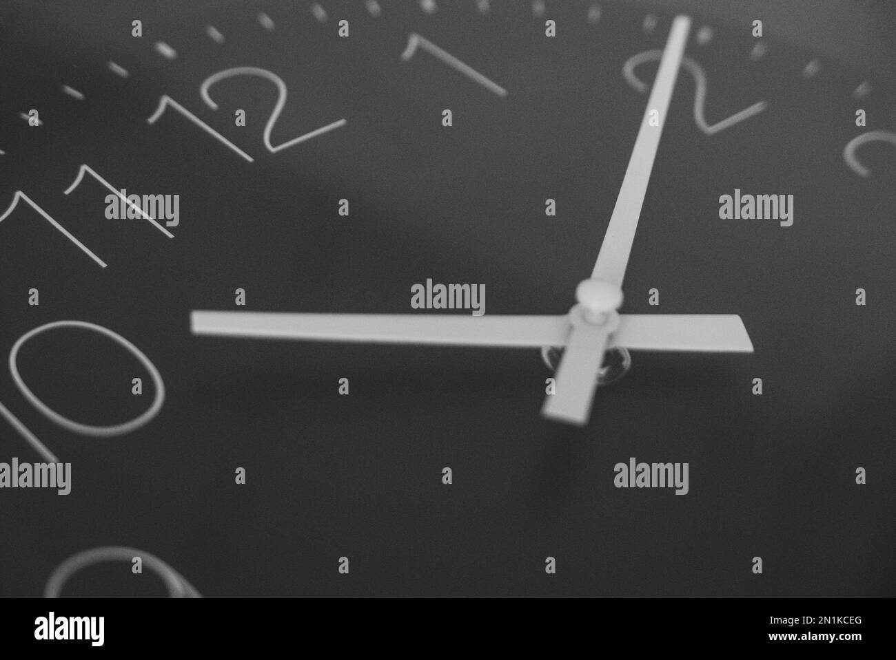 Selective focus of mechanical wall clock in black and white represent ...