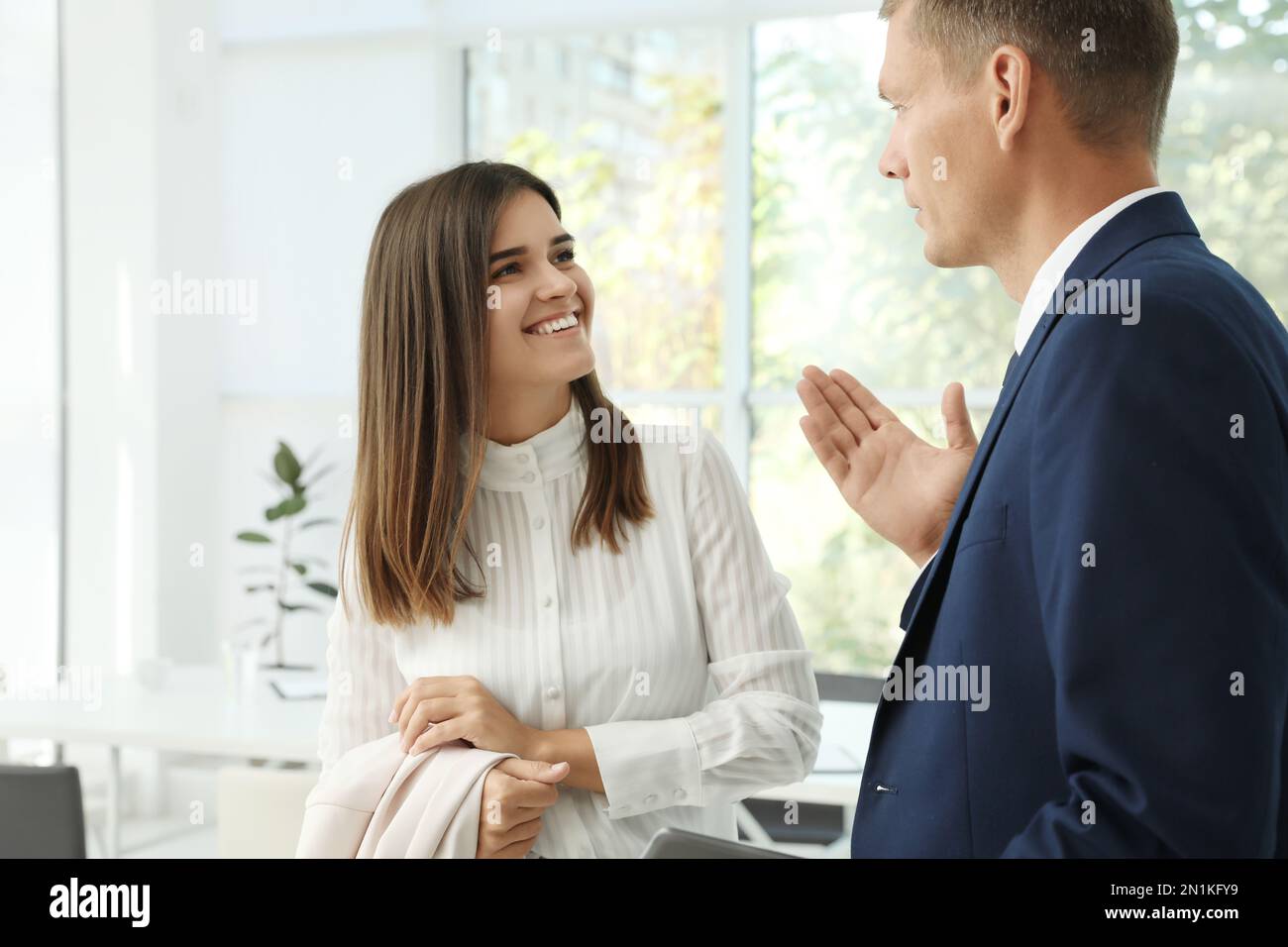 Office employees talking at workplace during break Stock Photo - Alamy