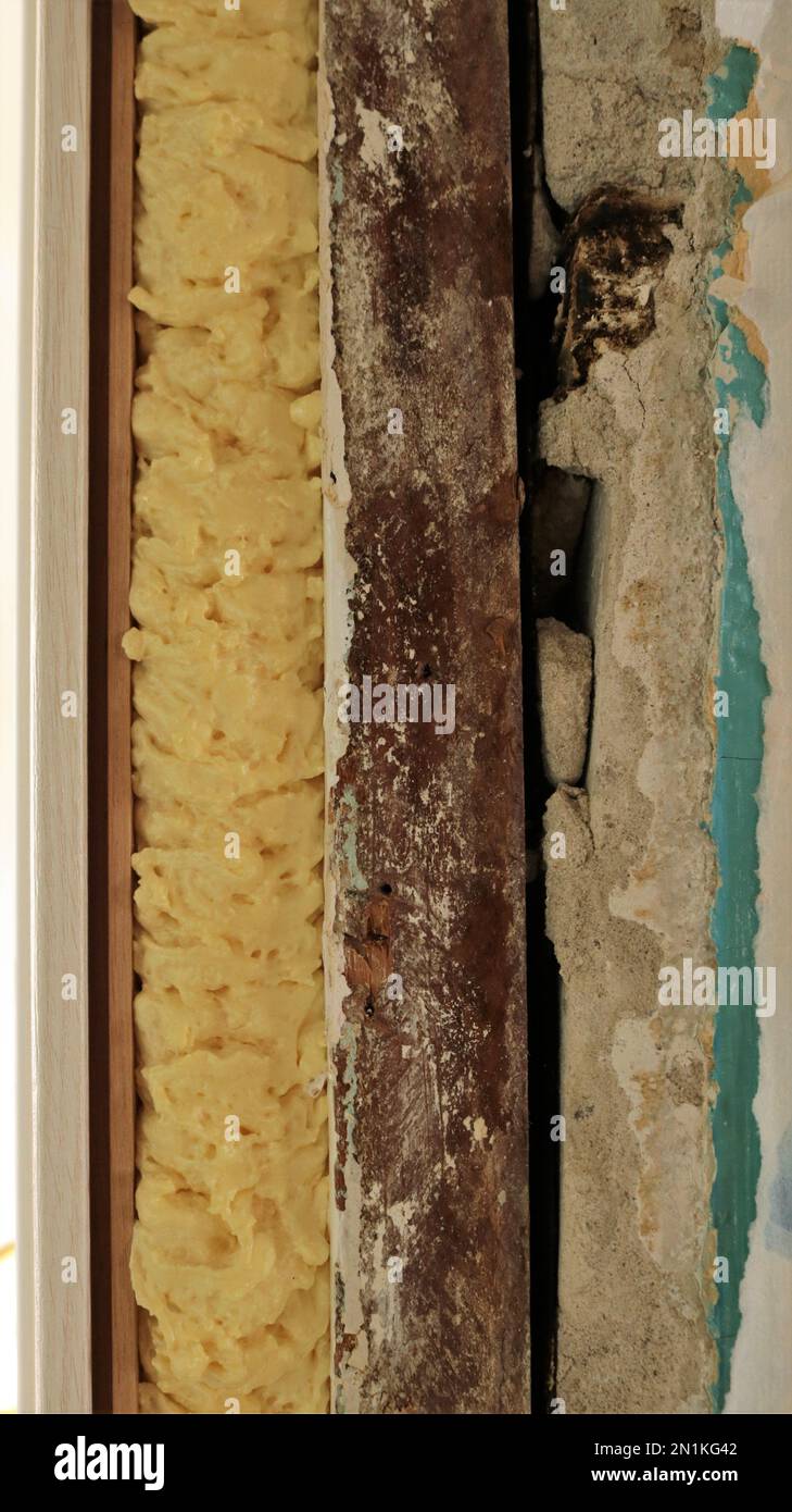 a fragment of the wall next to the doorway with a visible layer ...