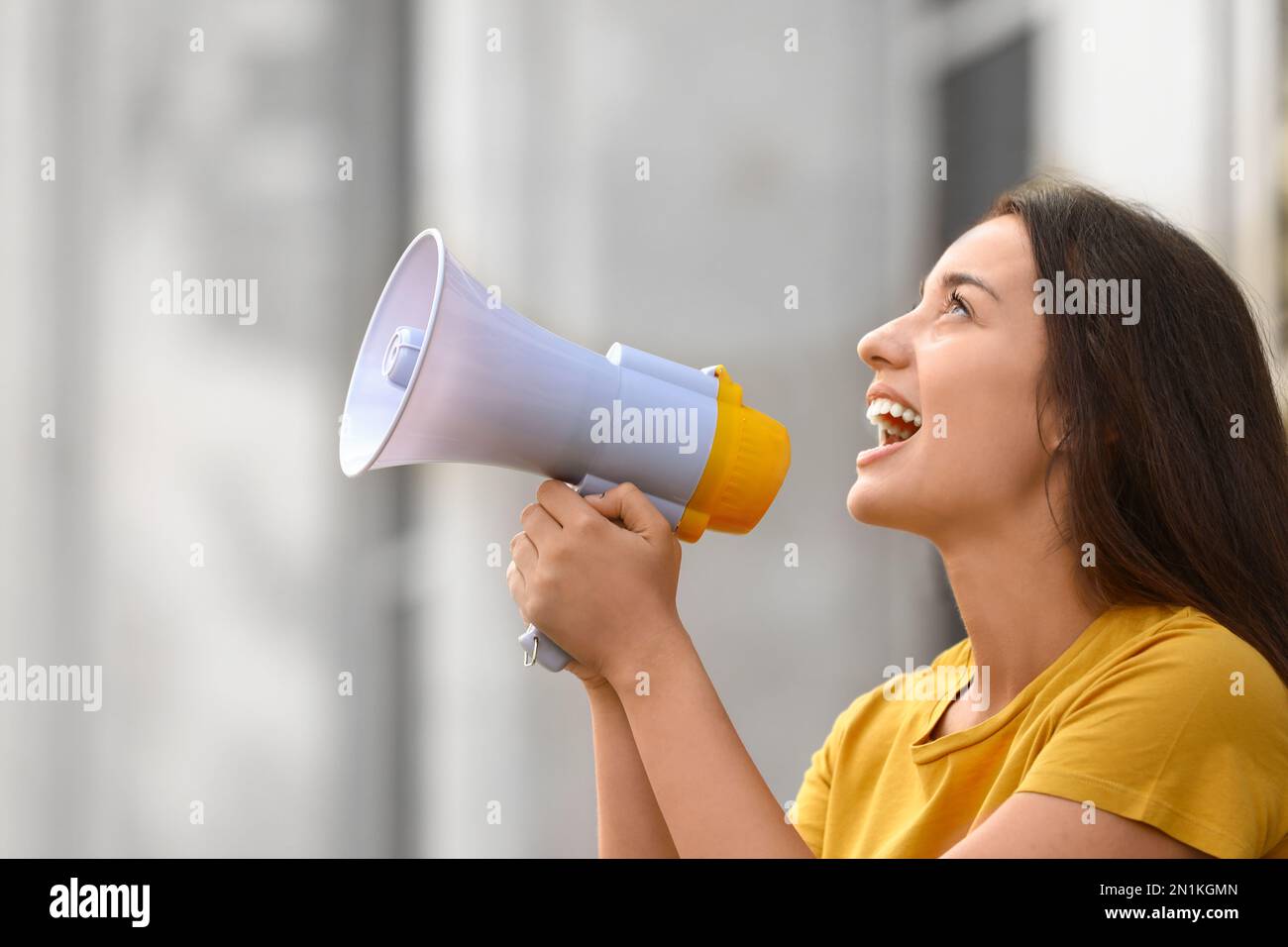 Emotional young woman with megaphone outdoors. Protest leader Stock ... Emotional young woman with megaphone outdoors. Protest leader Stock ...