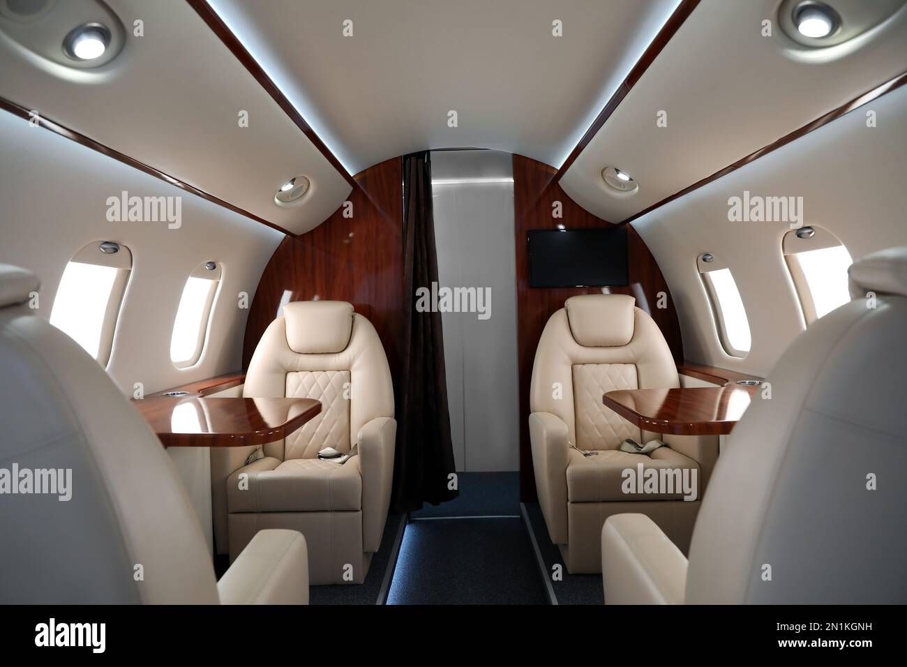 Airplane cabin with comfortable seats and tables Stock Photo - Alamy