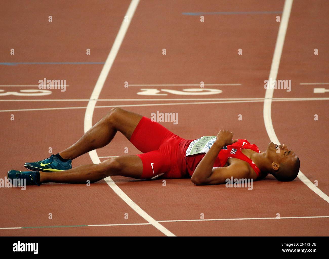 United States' Ashton Eaton collapses on the track after crossing the ...