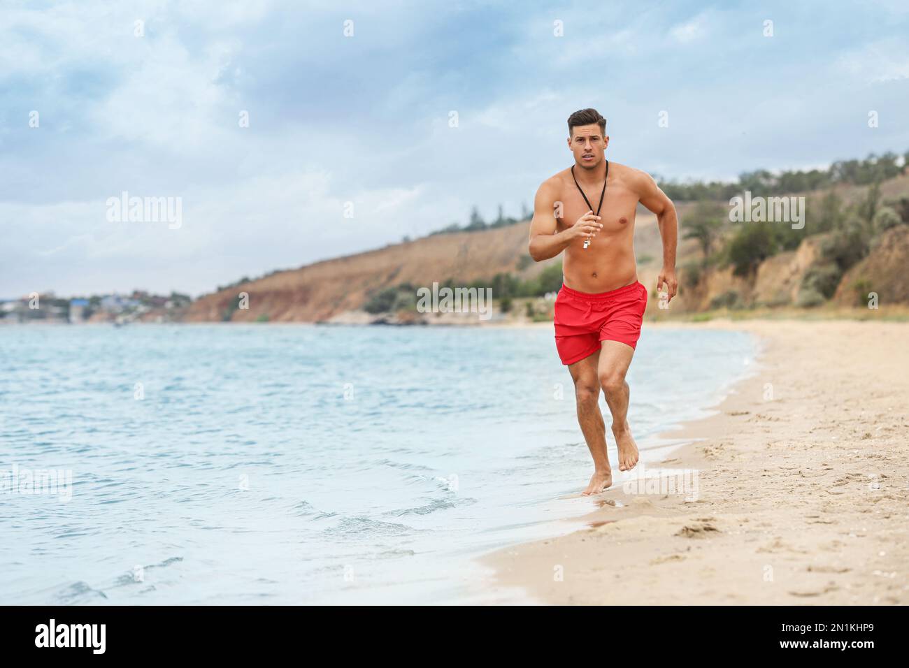 Handsome lifeguard red swimsuit hi-res stock photography and images - Alamy