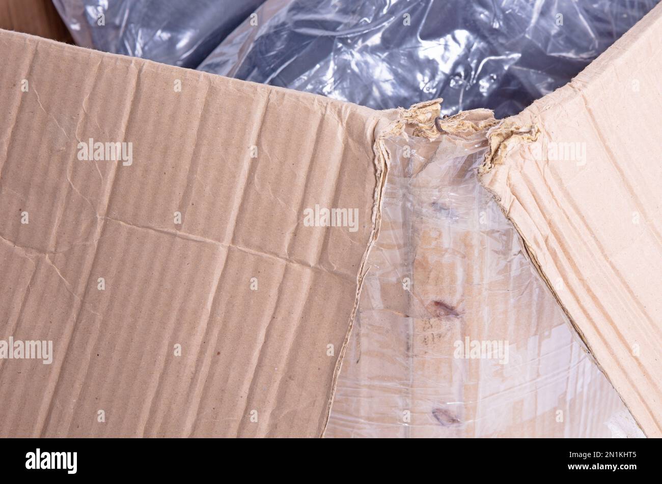 Battered cartboard box isolated on a white background Stock Photo - Alamy