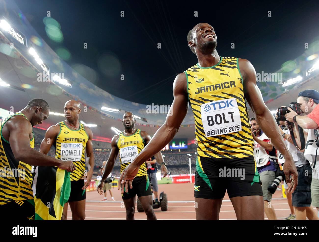 Jamaica's Usain Bolt, right, celebrates after anchoring the team to the ...