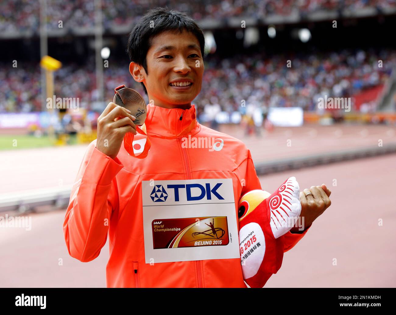 Japan's Takayuki Tanii smiles holding the bronze medal he won in the ...