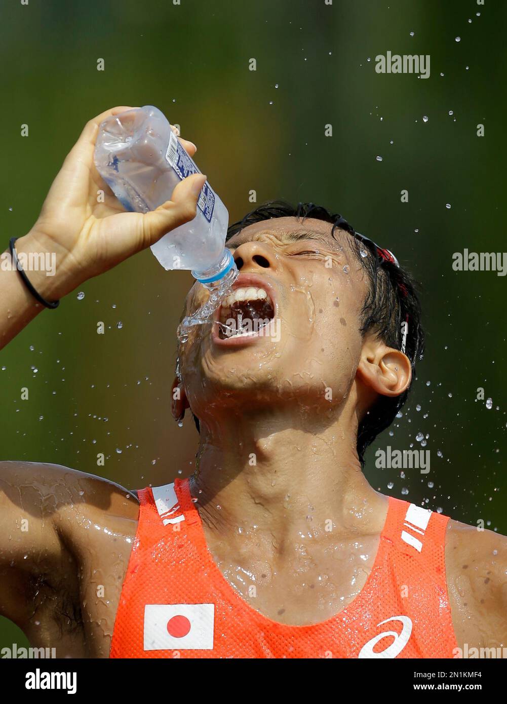 Japan's Takayuki Tanii drinks water during the men's 50k race walk at ...