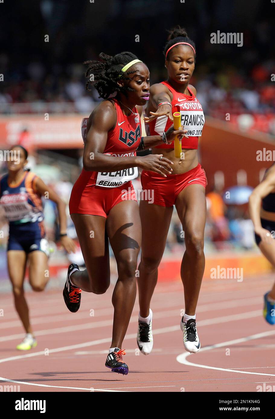 United States' Jessica Beard, left, gets the baton from Phyllis Francis ...