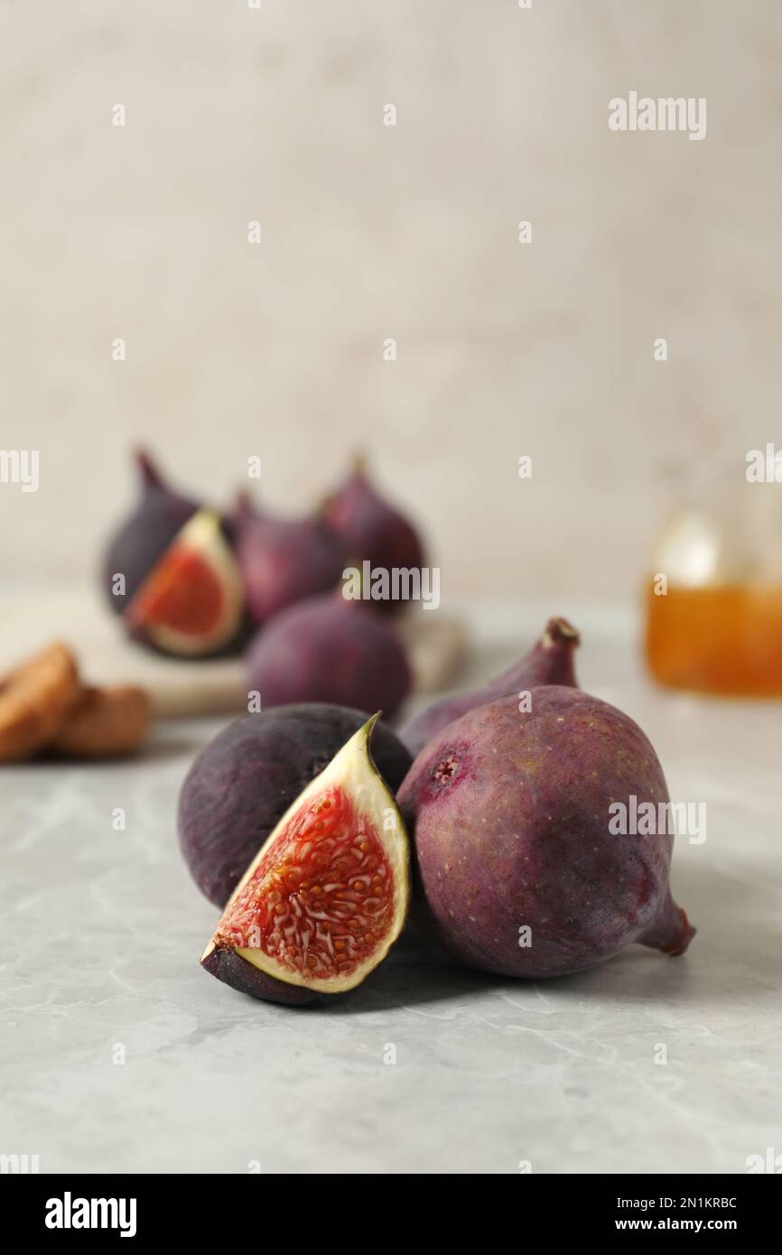 Tasty raw figs on light grey marble table, closeup Stock Photo - Alamy