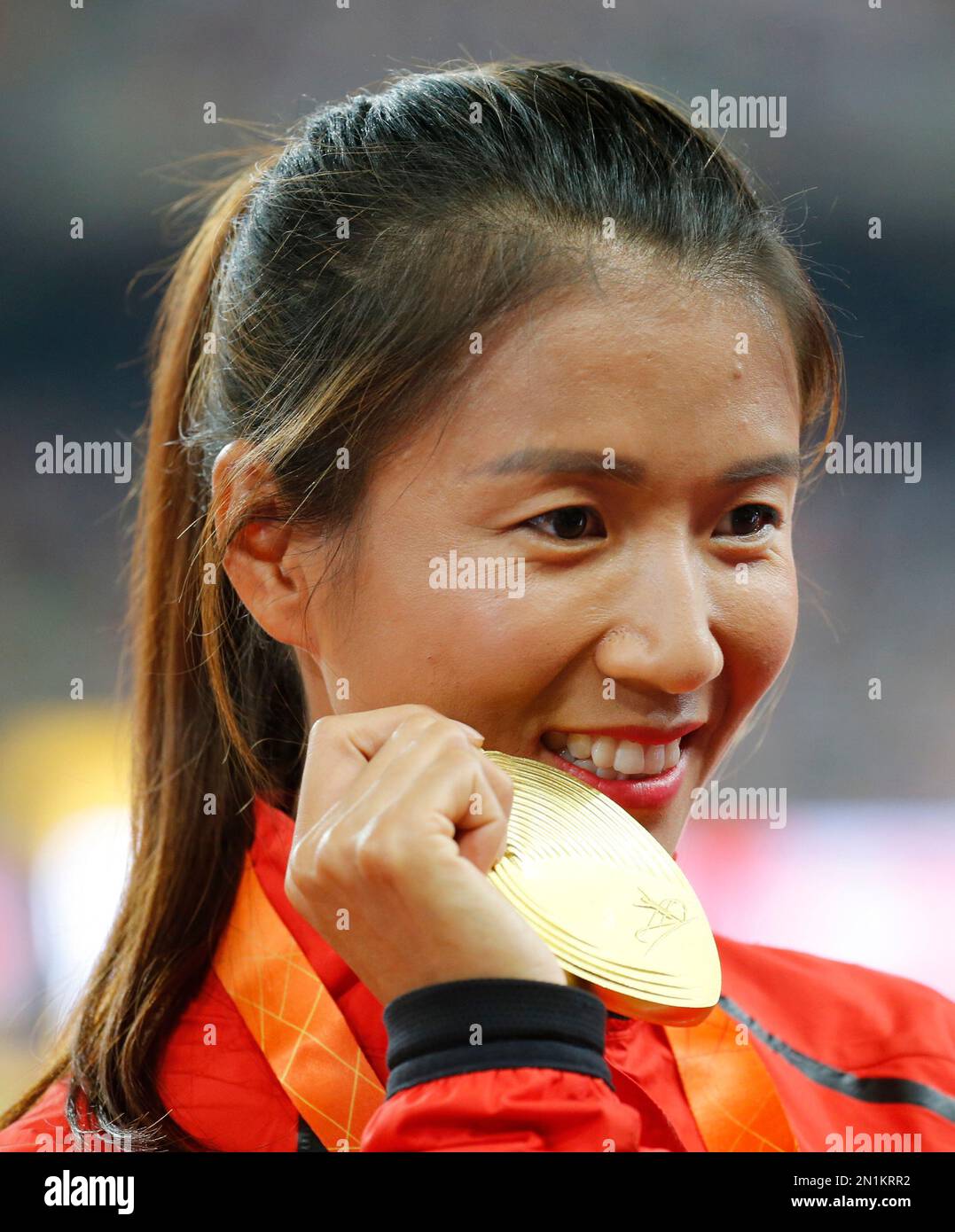 China's Liu Hong shows her gold medal of the women’s 20k race walk at ...
