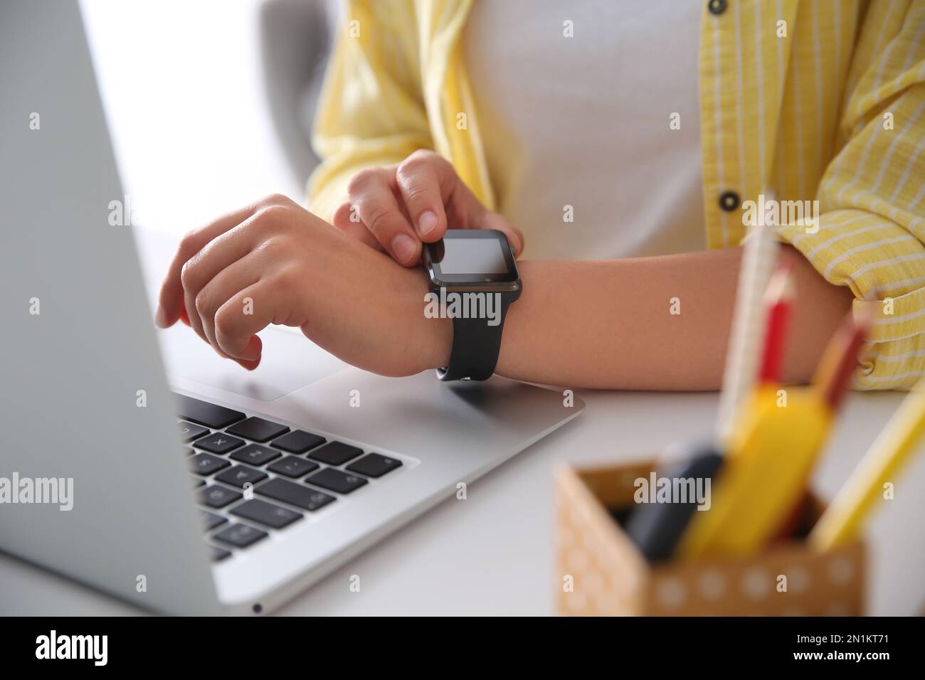 Woman checking clock office hi-res stock photography and images - Alamy