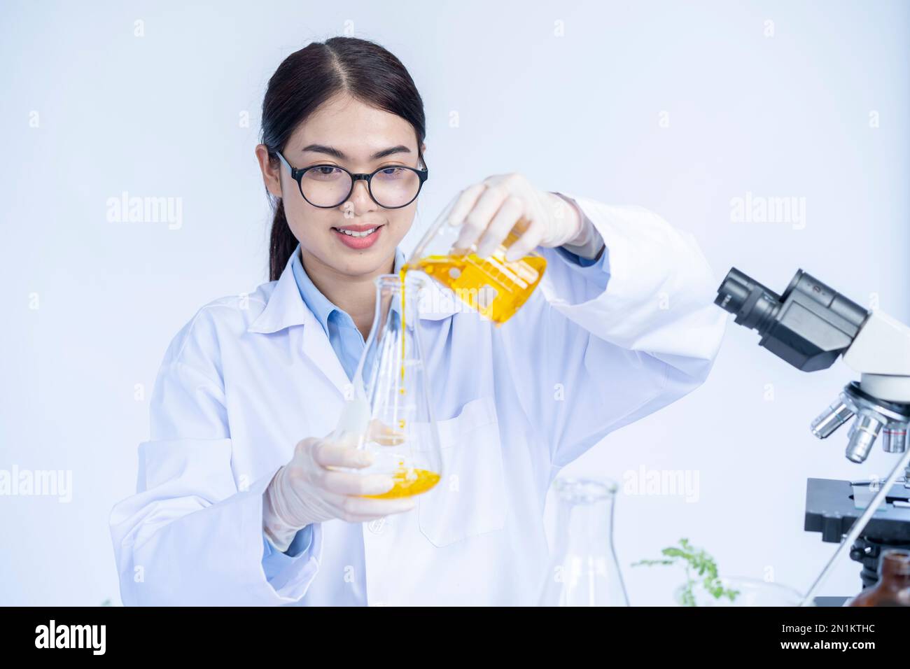 laboratory researcher holding medical glass bottle with yellow liquid ...