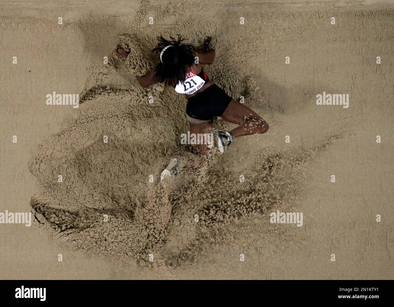 Canada's Christabel Nettey lands in the sand as she competes in the ...